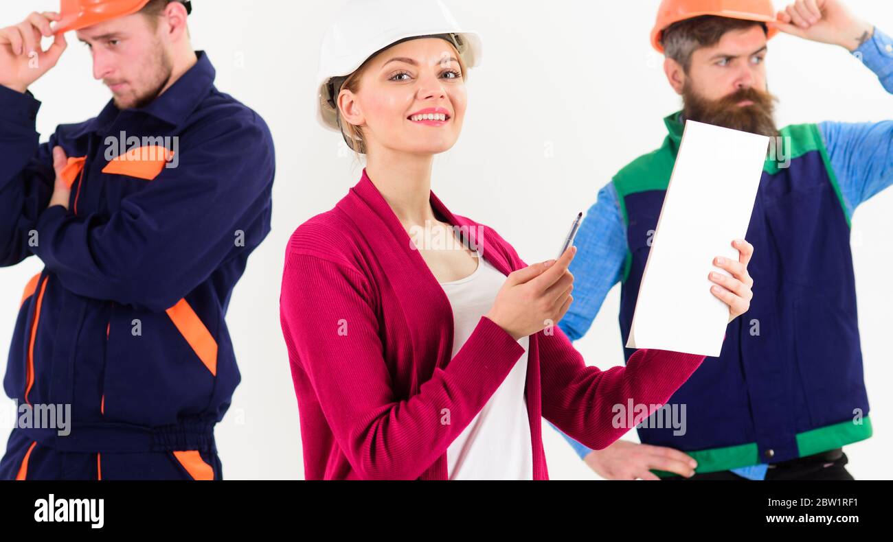 Team of architects, builders with woman manager, boss looks at document ...