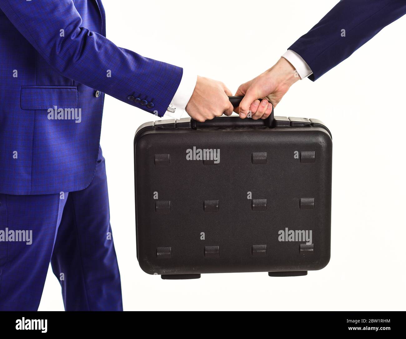 Successful business deal concept. Male hands in suits hold black ...