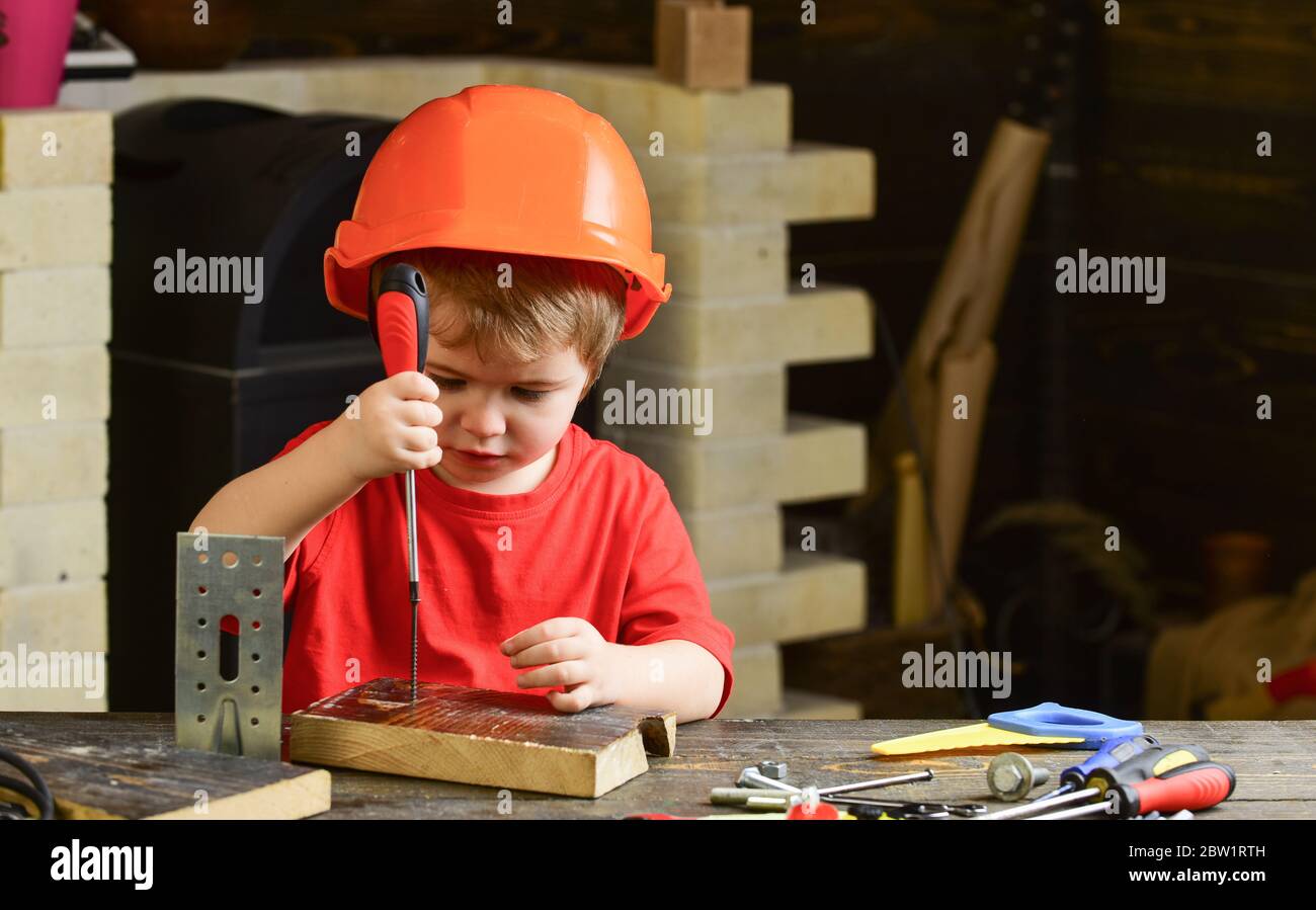 Boy play as builder or repairer, work with tools. Child dreaming about ...