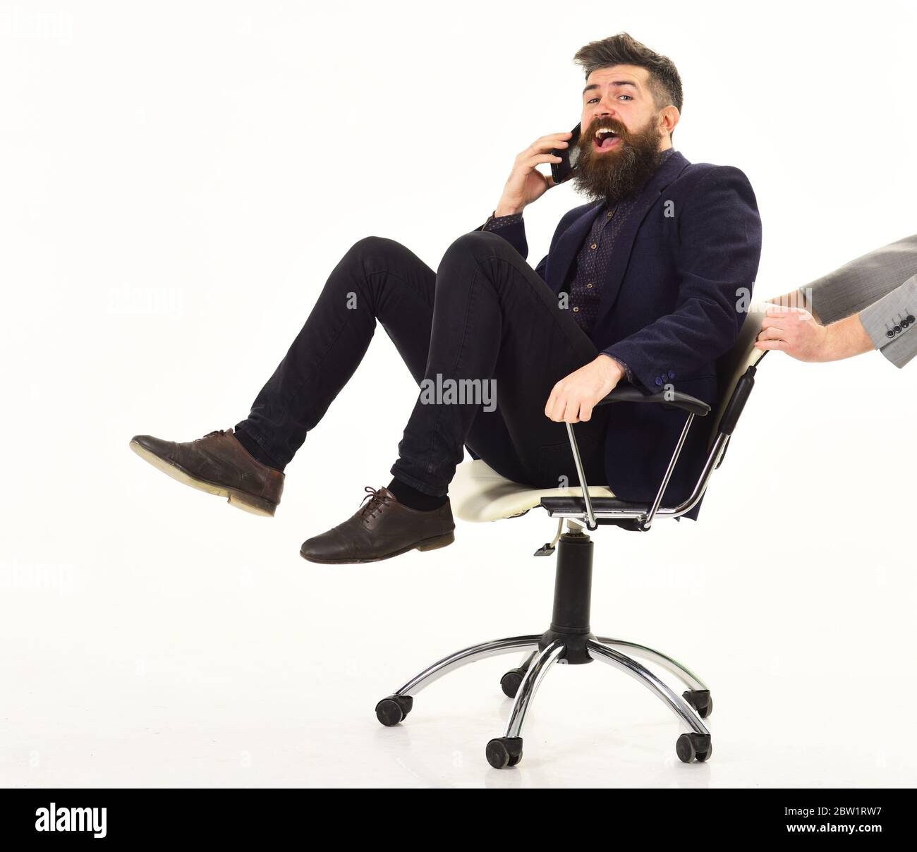Businessman talking on the phone sitting in a chair. Isolated on white ...