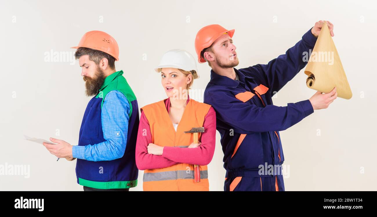Men and woman in helmets carefree with hammer and project, white ...