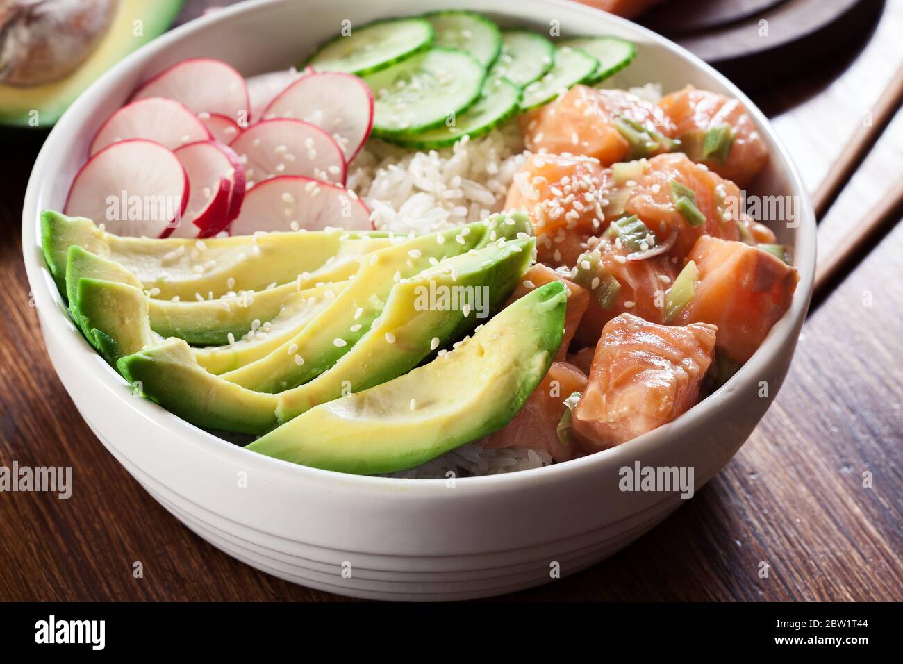Poke bowl, traditional Hawaiian raw fish salad with rice, avocado ...