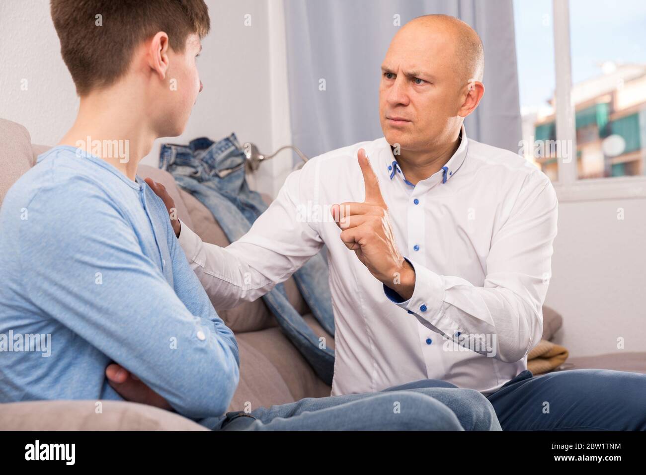 Father lecturing his teenage son at home Stock Photo - Alamy
