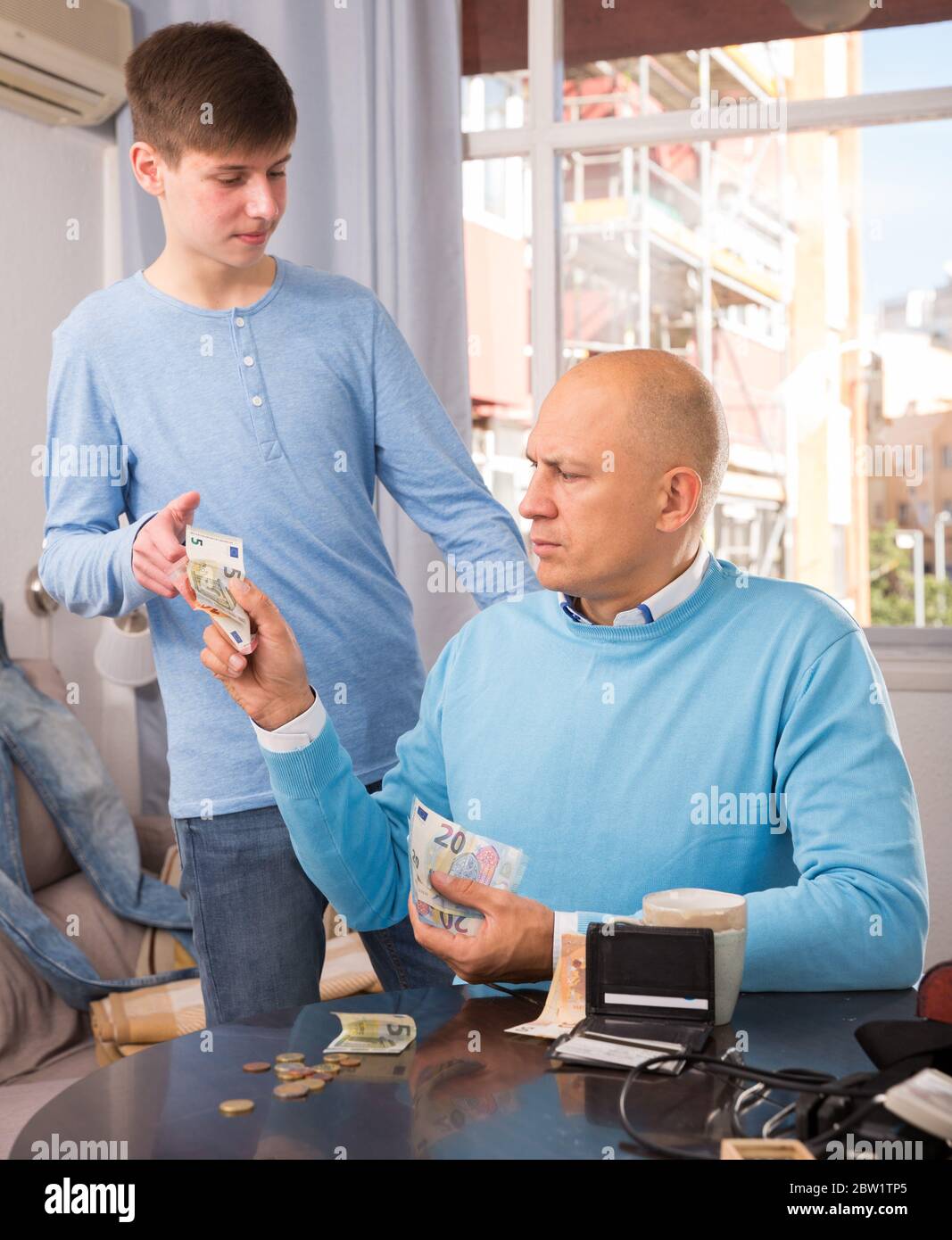 Boy receiving money hi-res stock photography and images - Alamy