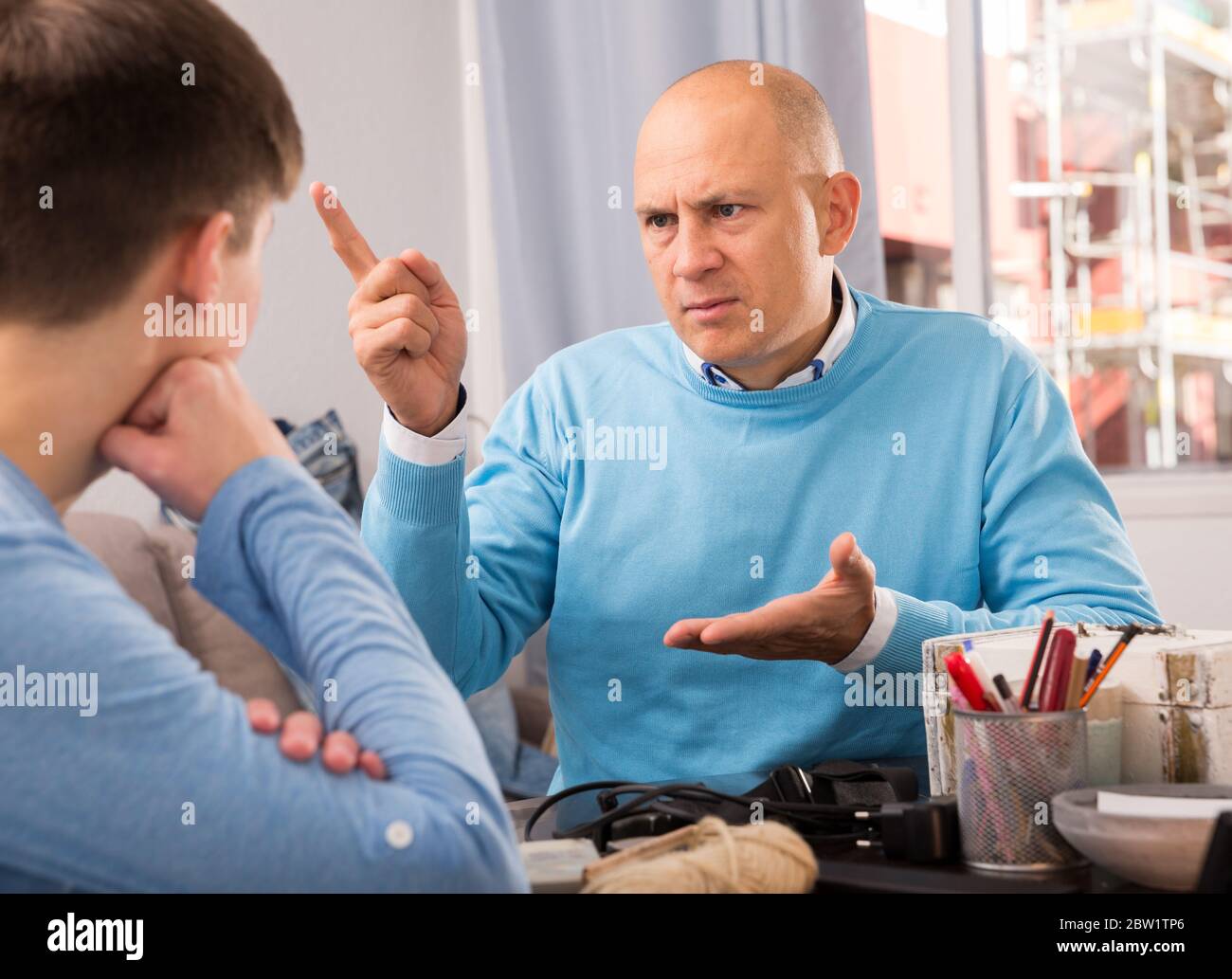 Serious father lecturing his son teenager at home Stock Photo - Alamy