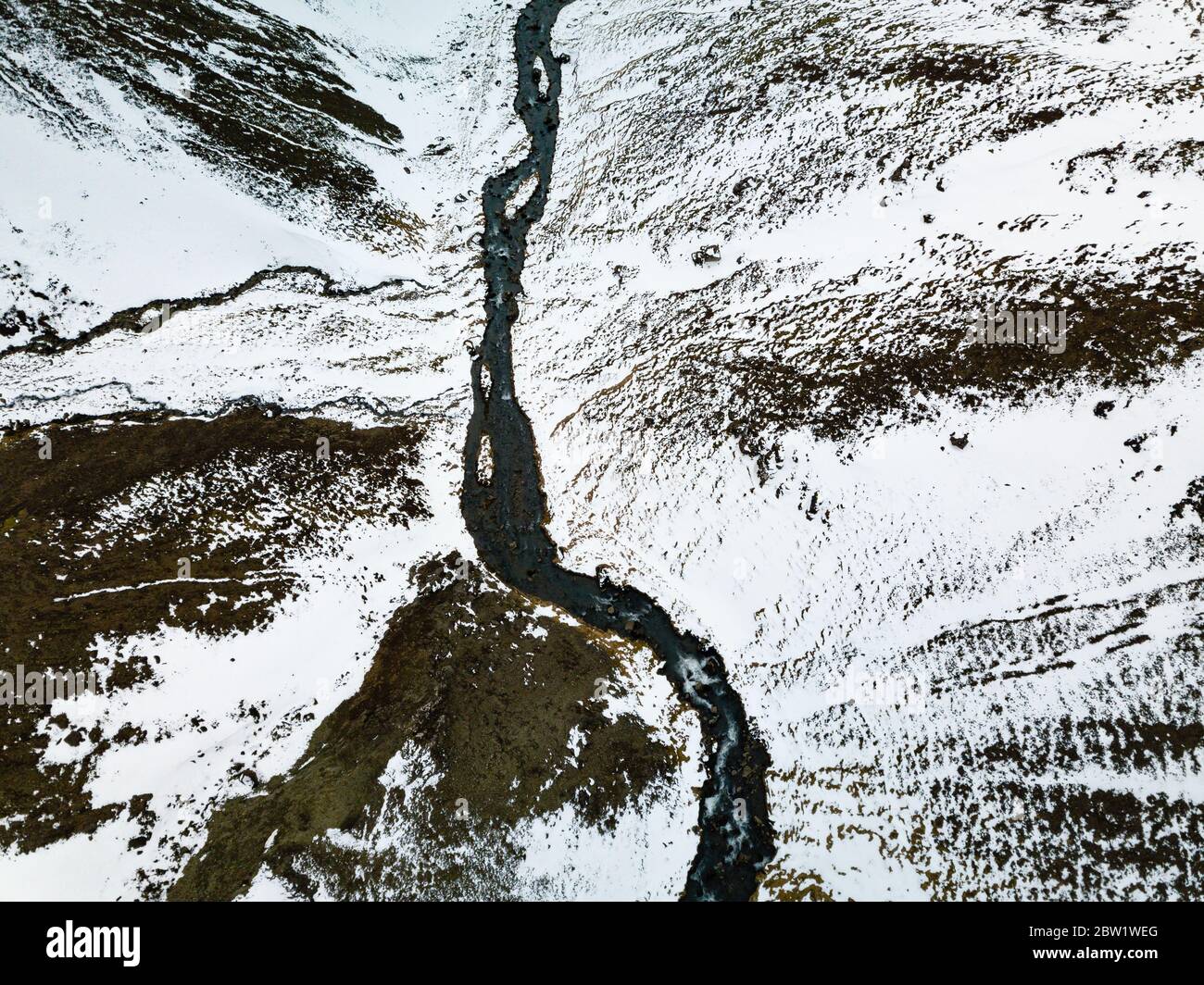 Birds eye view of a small stream running through the snow Stock Photo ...