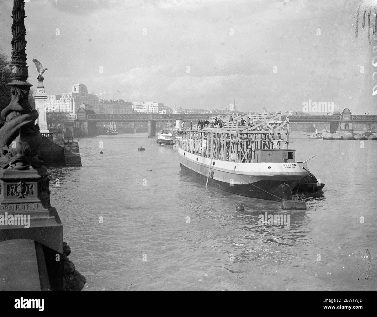 Red white and blue Coronation barge. Coronation Stand is being built on ...