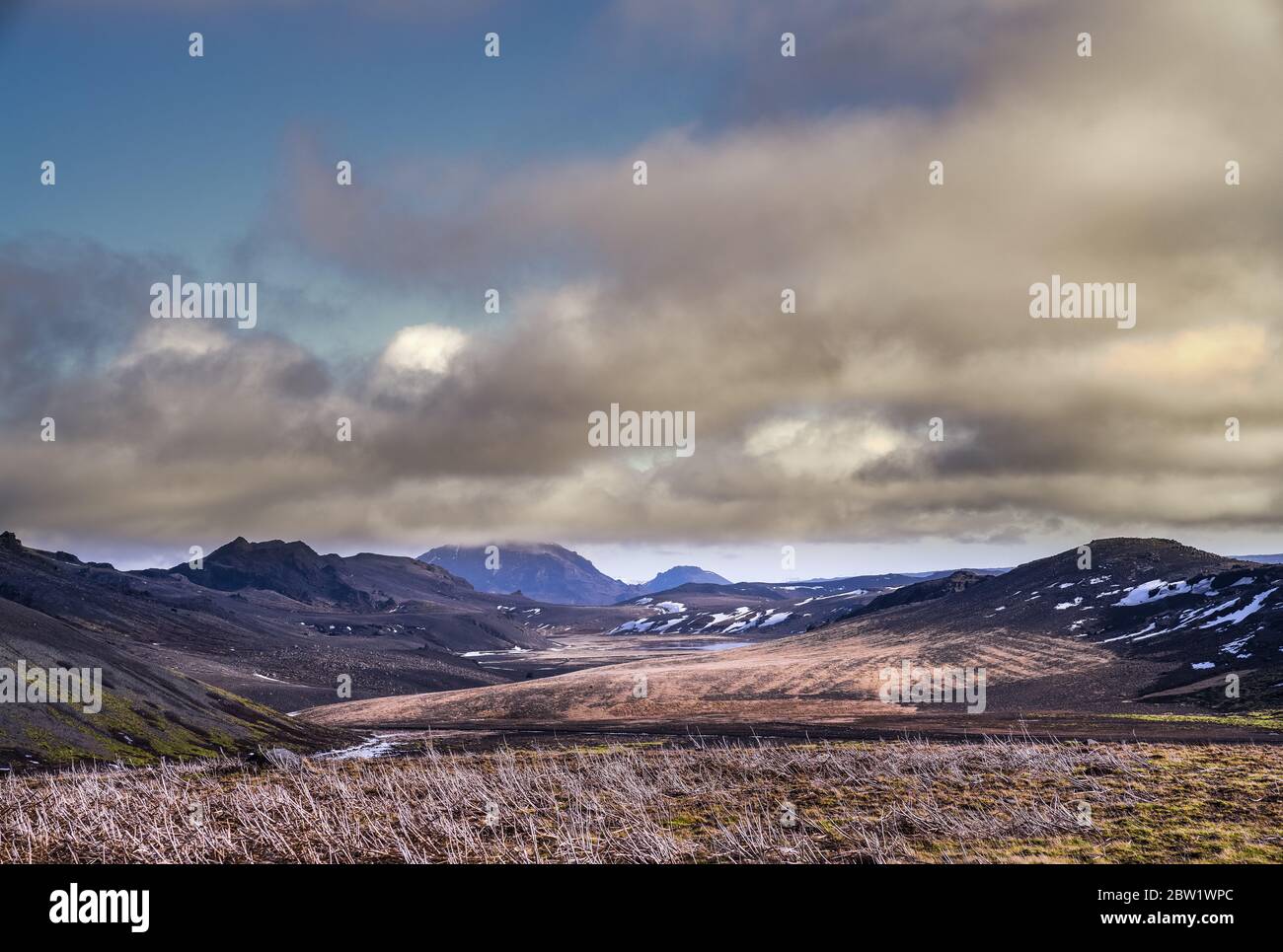 Dramatic Icelandic landscape featuring an old farm field and and partly ...