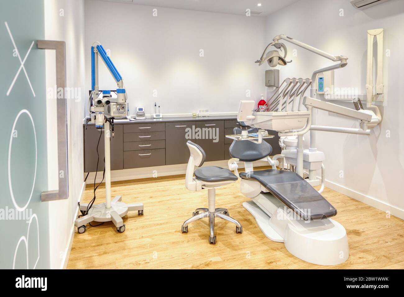 Fully equipped modern dental clinic box, with white walls and wooden ...