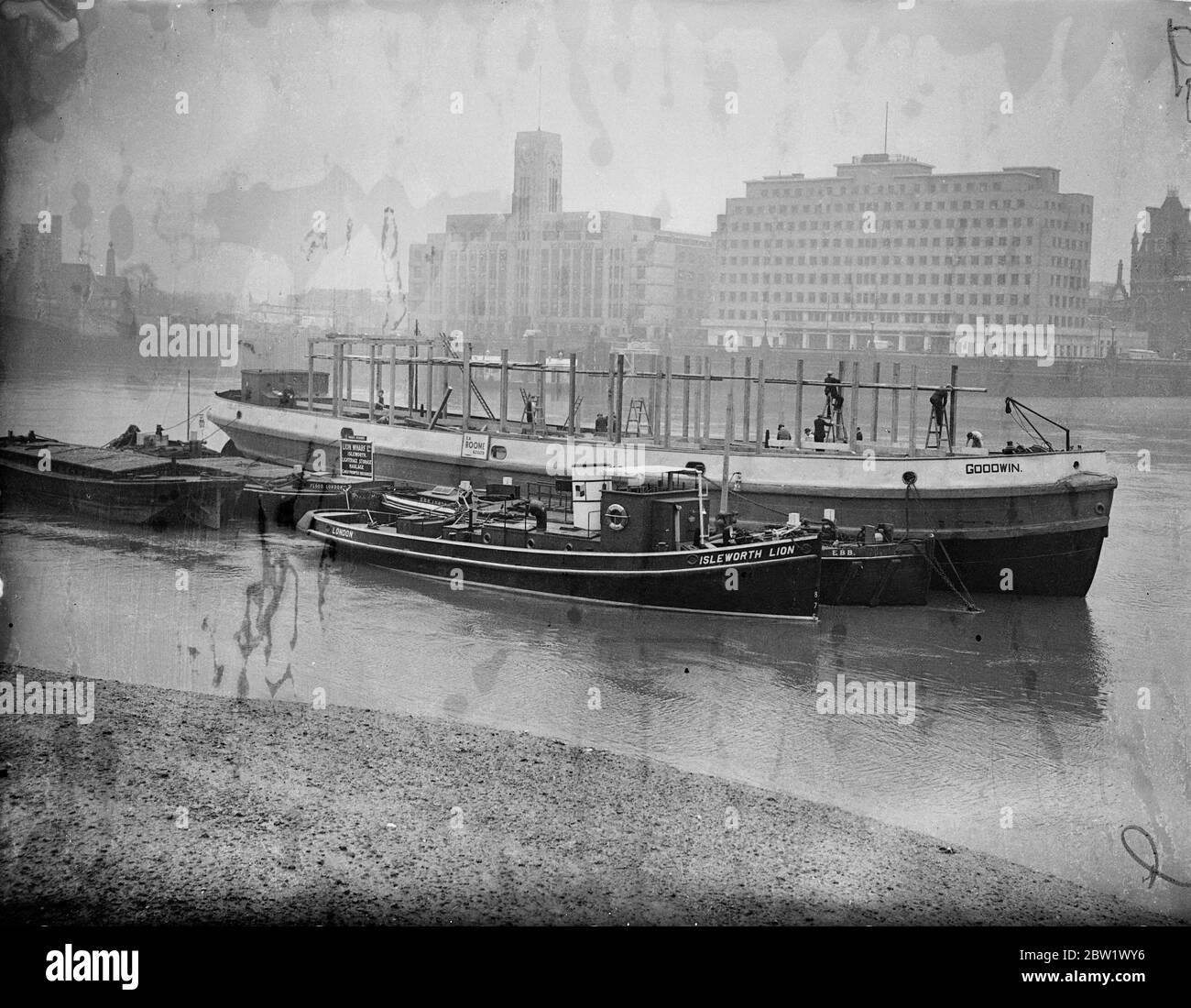 Red white and blue Coronation barge. Coronation Stand is being built on ...