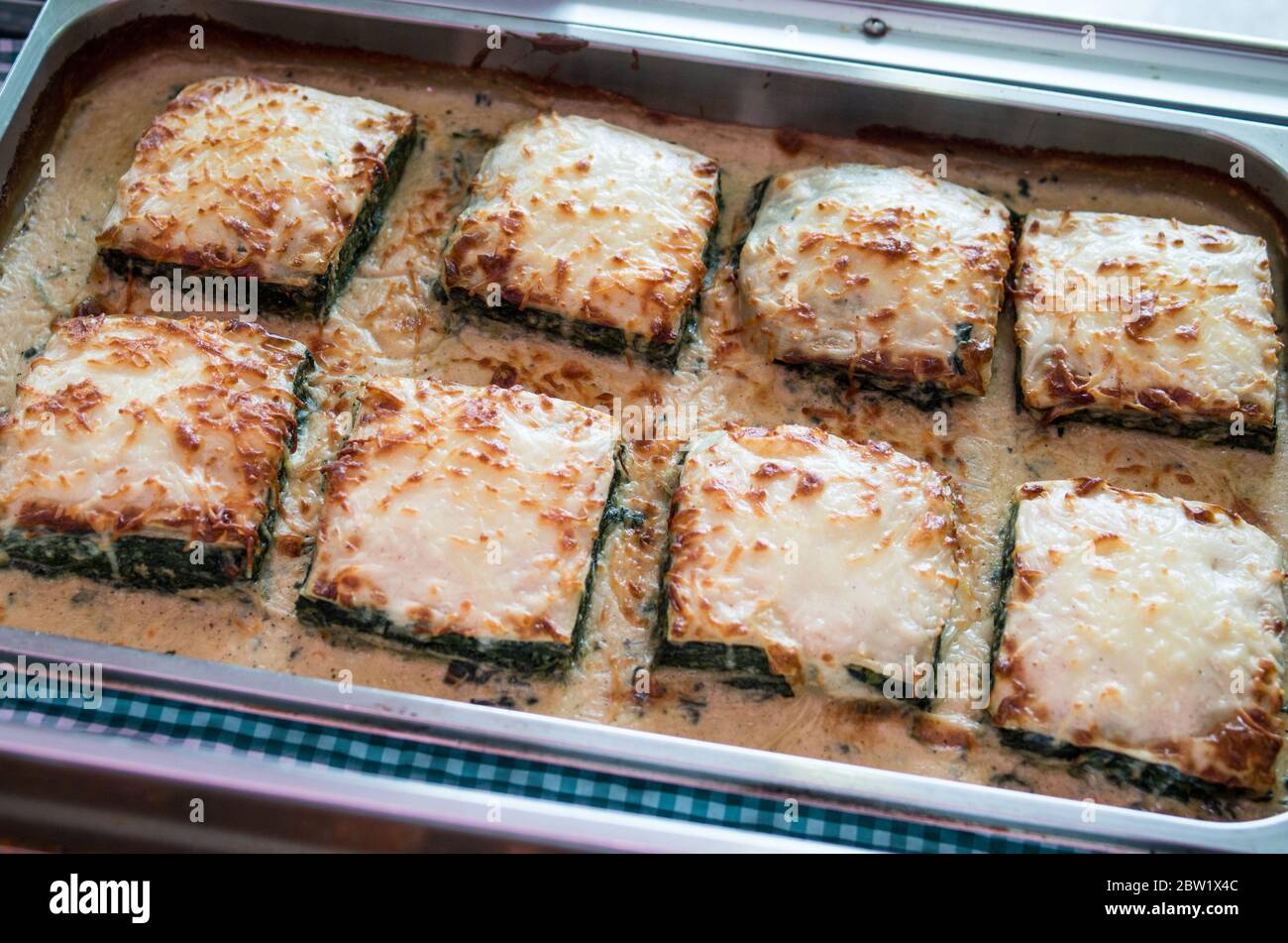 Cannelloni stuffed with spinach with different melted cheeses in an ...