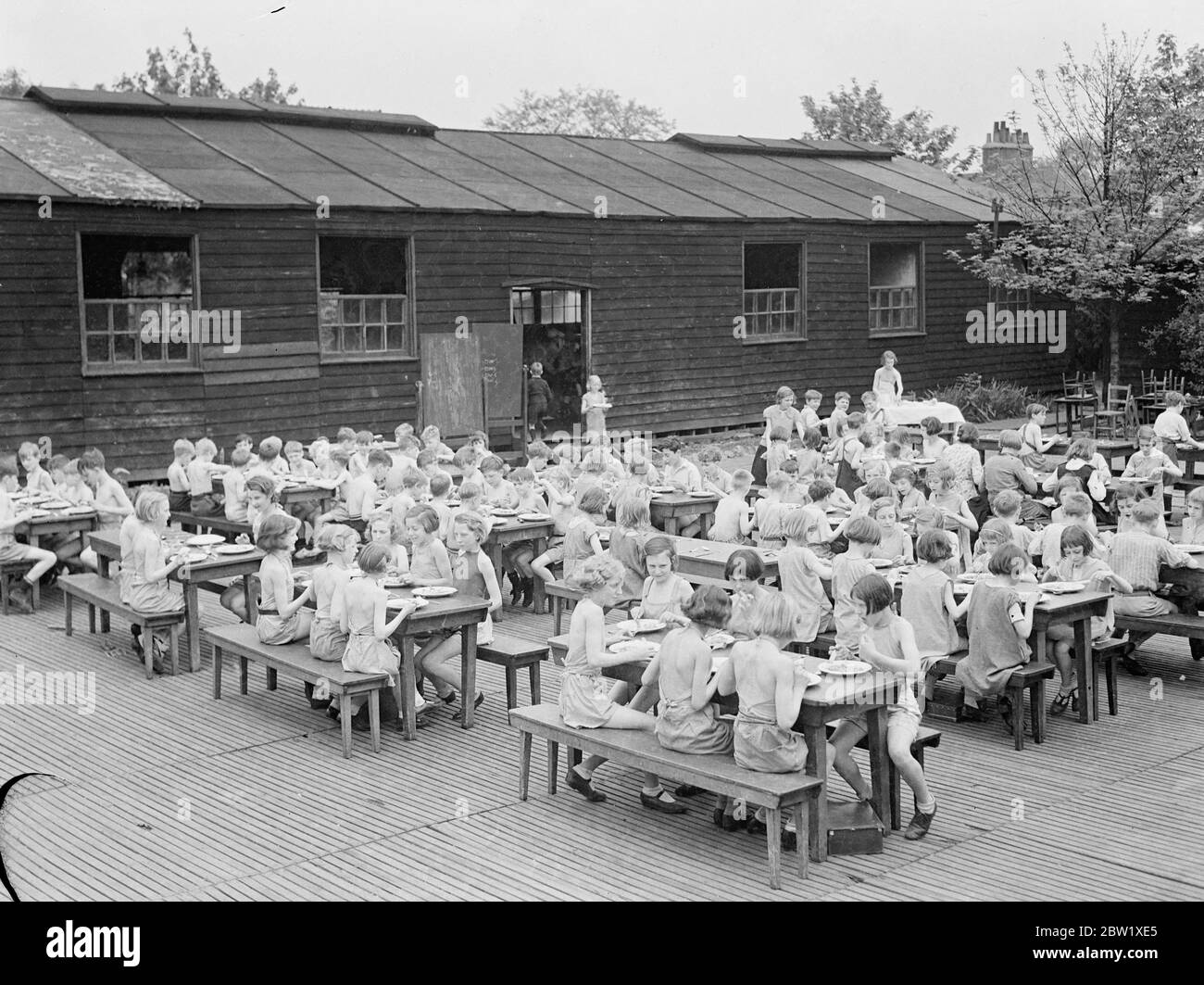 Fresh air aids the appetite. East End's open-air school. The minimum of ...