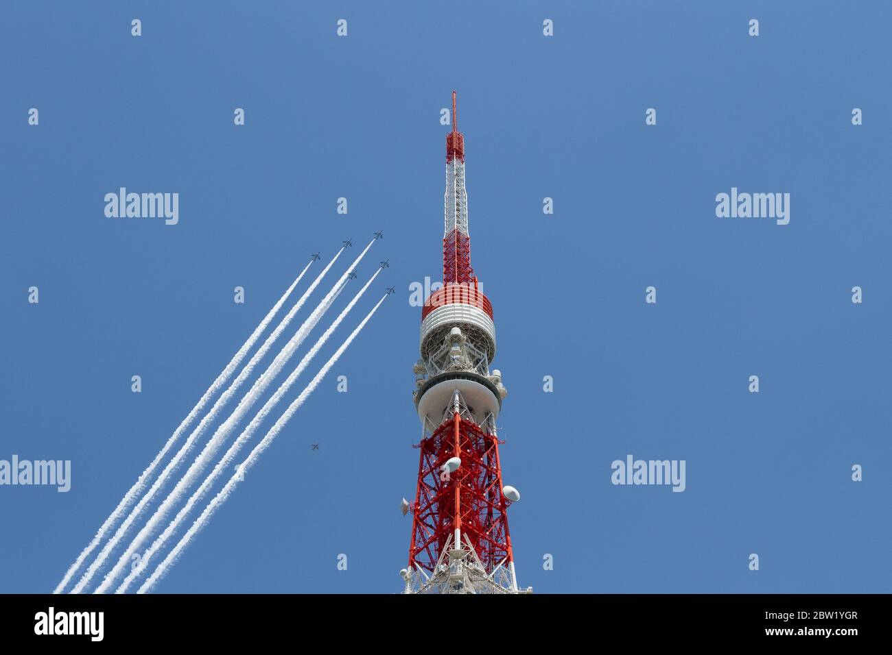 The JASDF Blue Impulse aerobatics team do a fly past over Tokyo Tower ...
