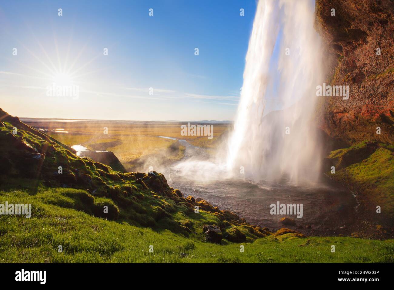 Seljalandsfoss waterfall in Iceland with midnight sun in June Stock ...