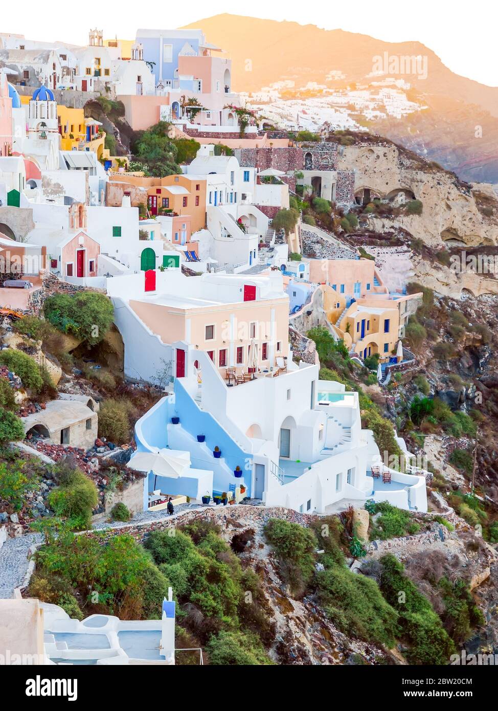 Traditional white cave houses on a cliff on the island Santorini ...