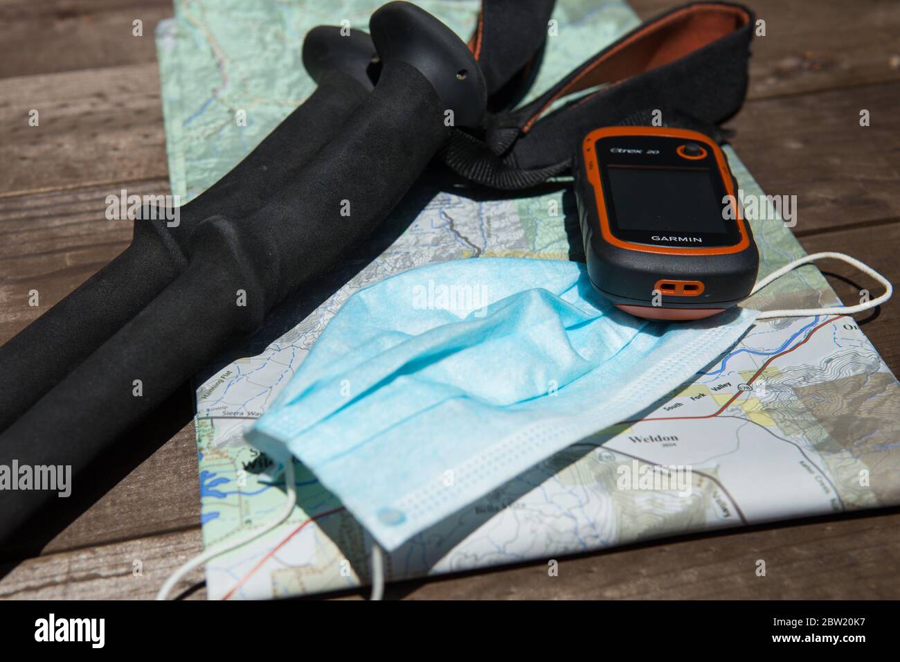 face mask for protection while hiking , hiking poles, and a gps on a ...
