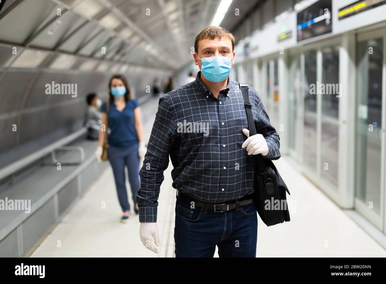 Portrait of male passenger in disposable face mask and latex gloves ...
