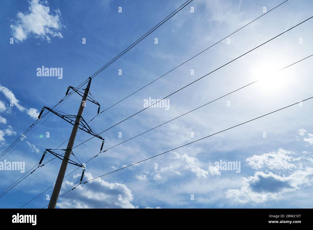 high-voltage electric line against a bright beautiful sky Stock Photo ...