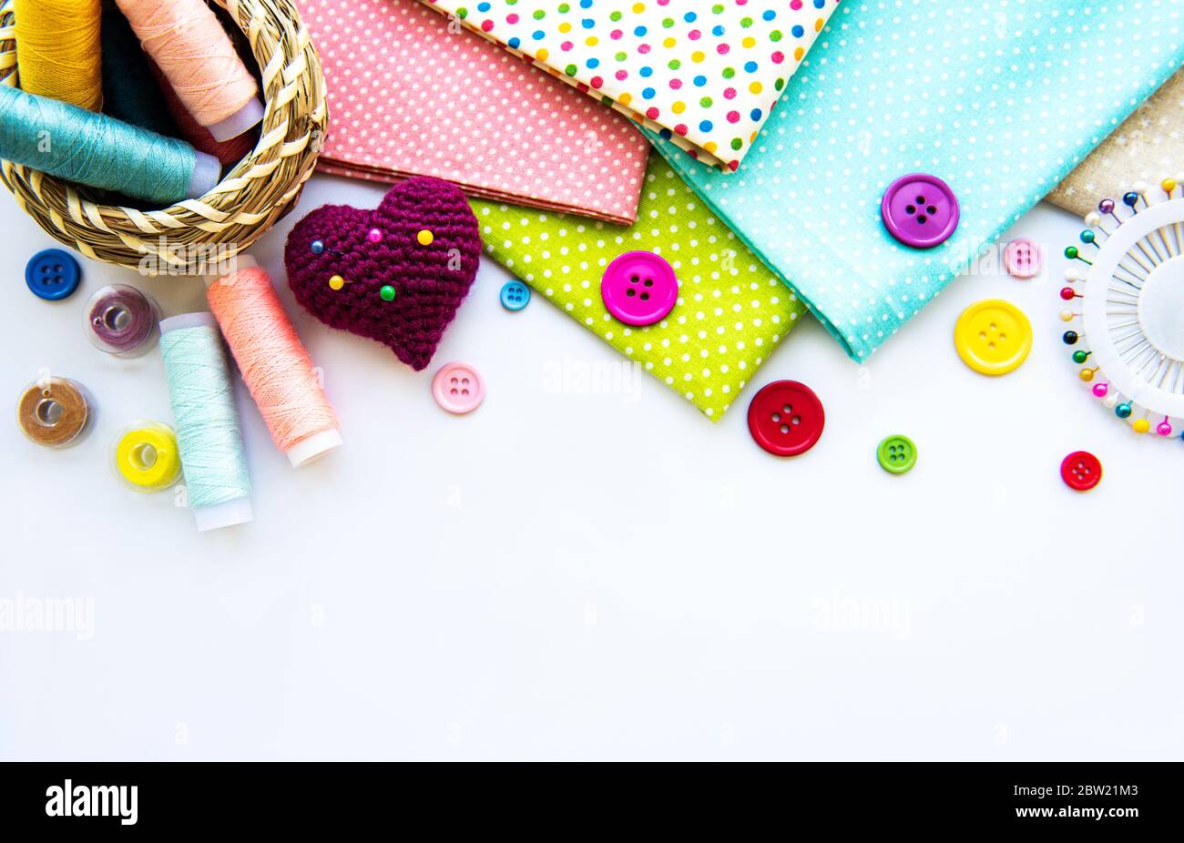 Sewing accessories and fabric on a white background. Sewing threads ...