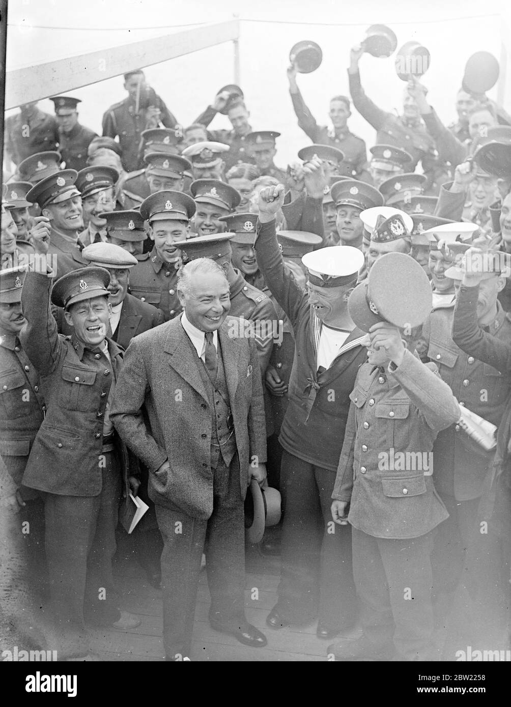 Mr Leslie Hore-Belisha being observed by soldiers and their families ...