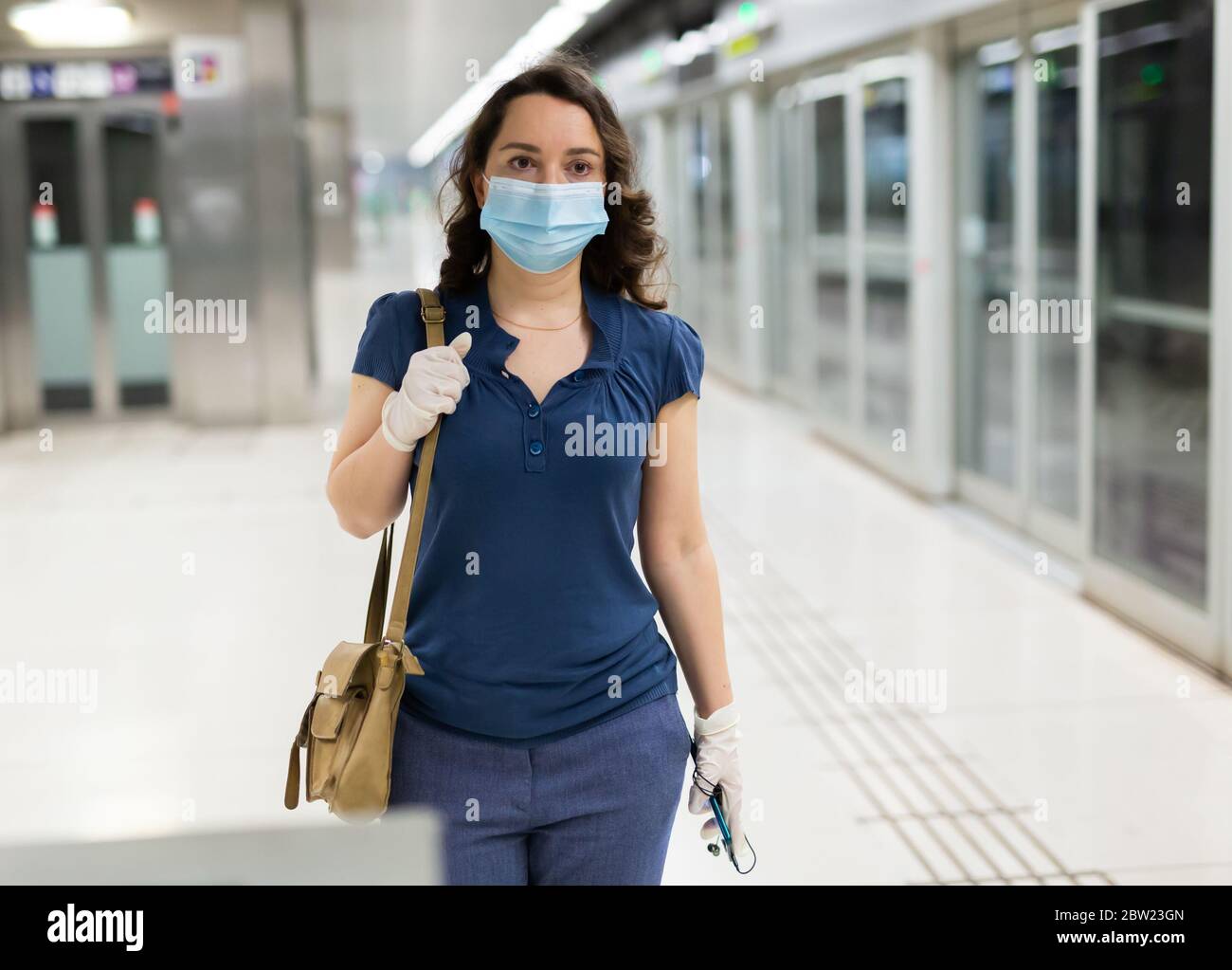 Portrait of female passenger in disposable face mask and latex gloves ...