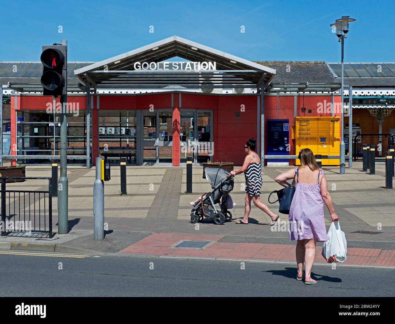Woman on pedestrian crossing in front of the railway station, Goole ...