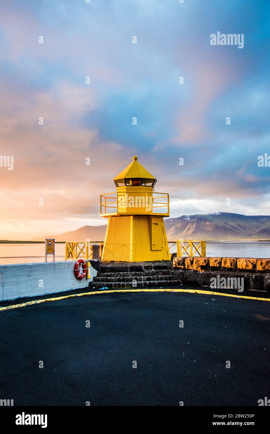 yellow lighthouse on port entrance Stock Photo - Alamy