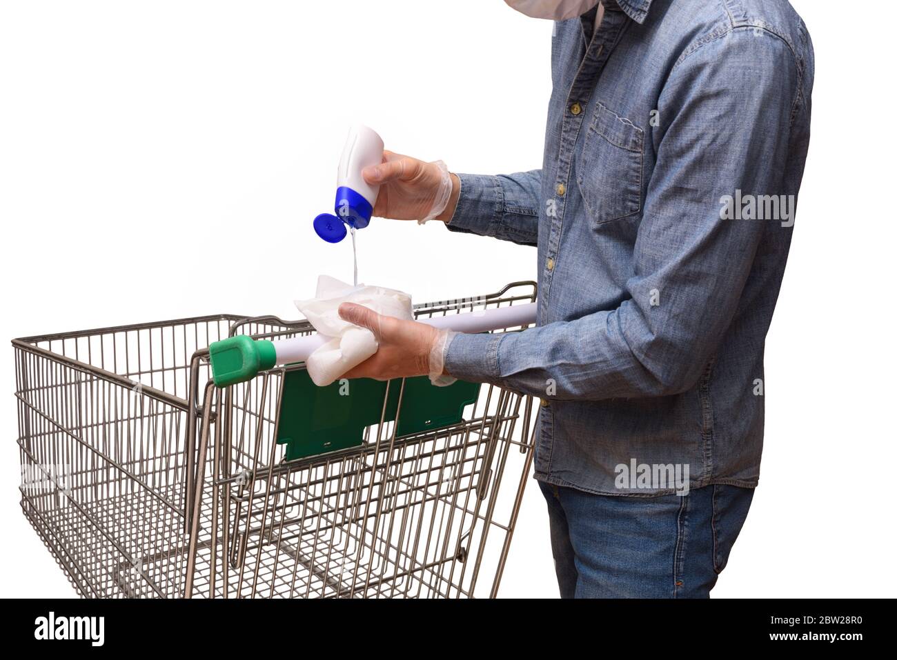Supermarket consumer cleaning the shopping cart with disinfectant ...