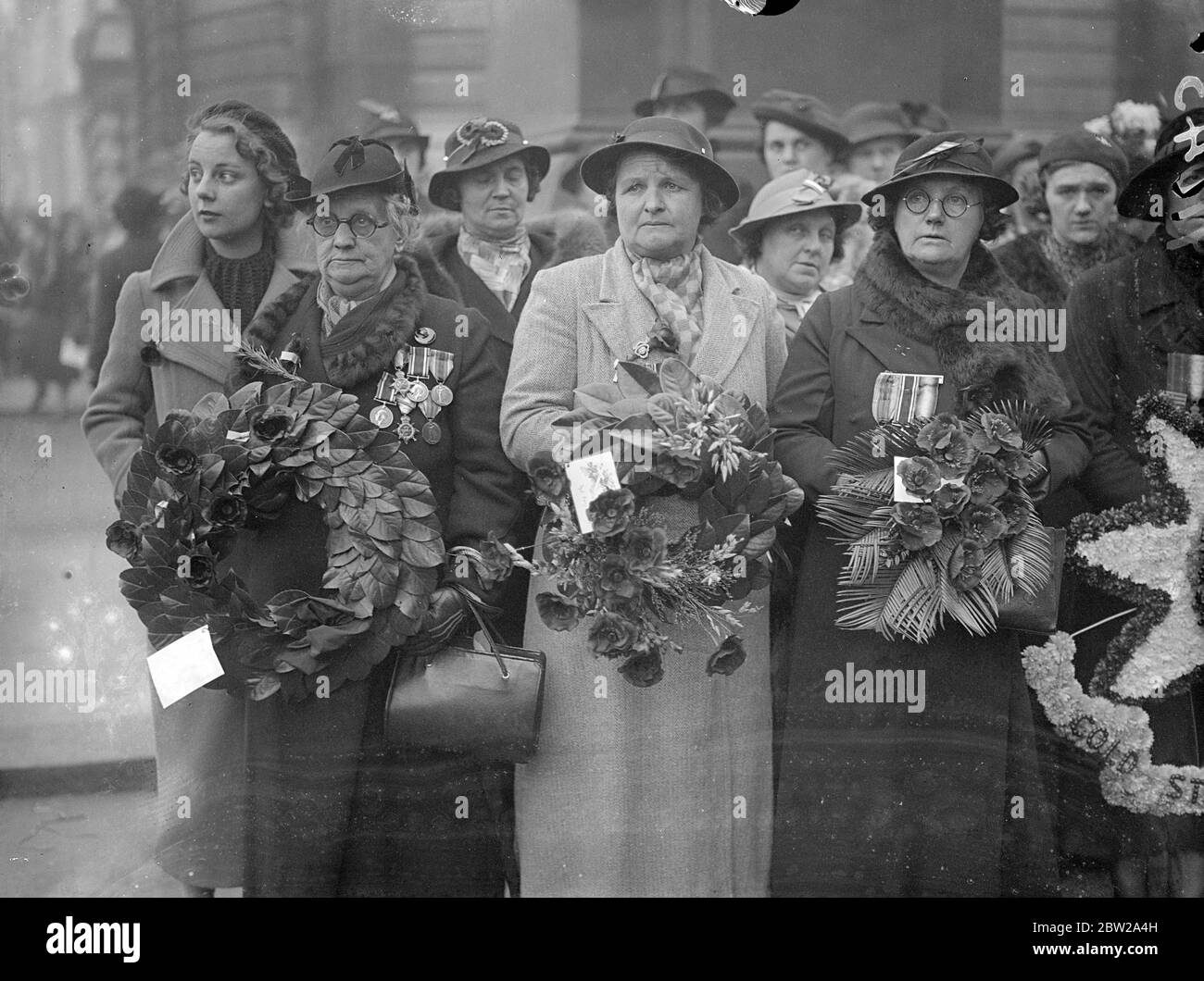 Women mourners with their wreaths at the Cenotaph. Three women mourners ...