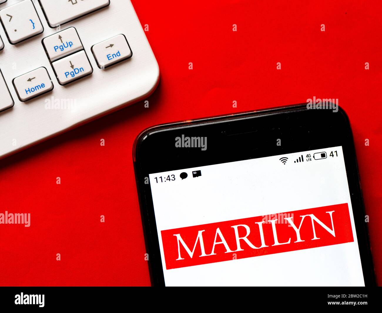 In this photo illustration e-commerce Marilyn logo is seen displayed on a smartphone Stock Photo ...