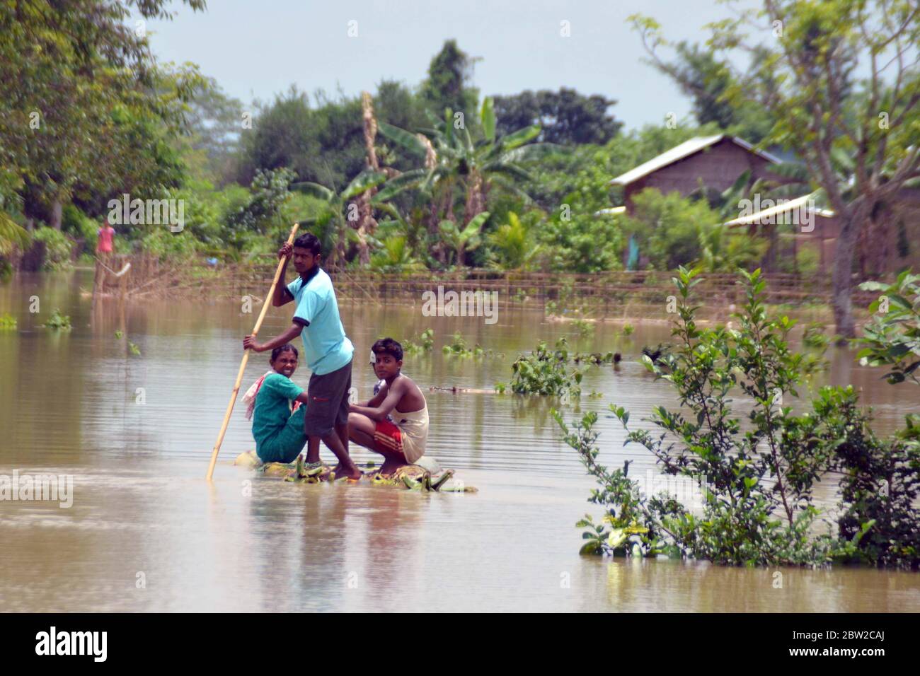 :A flood affected family on a banana raft moves towards a highland due ...