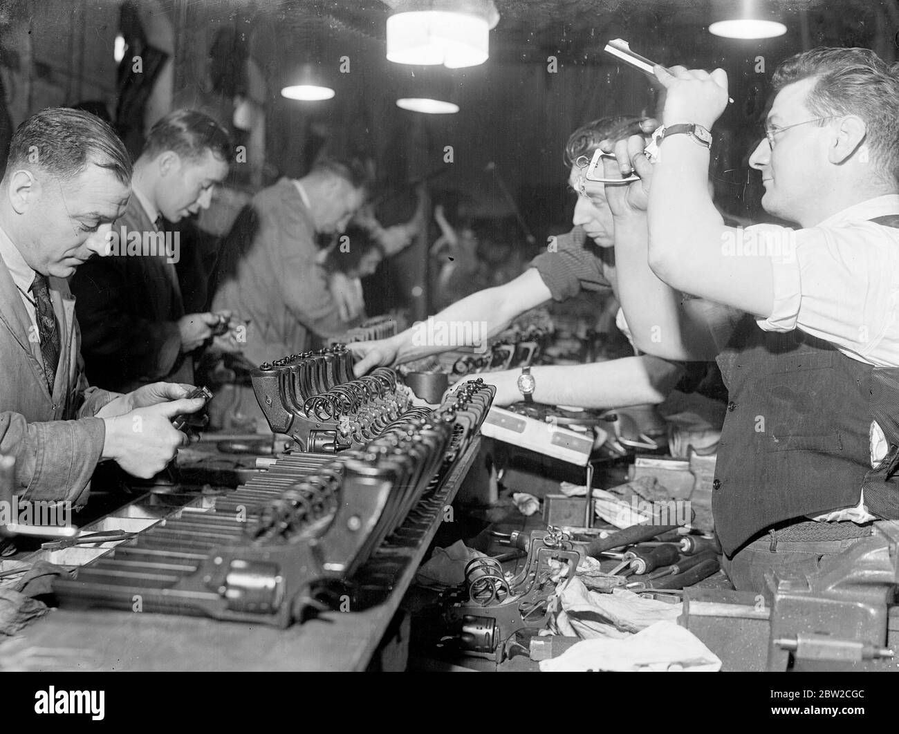 Turning out small arms by the thousand in a British factory. These ...