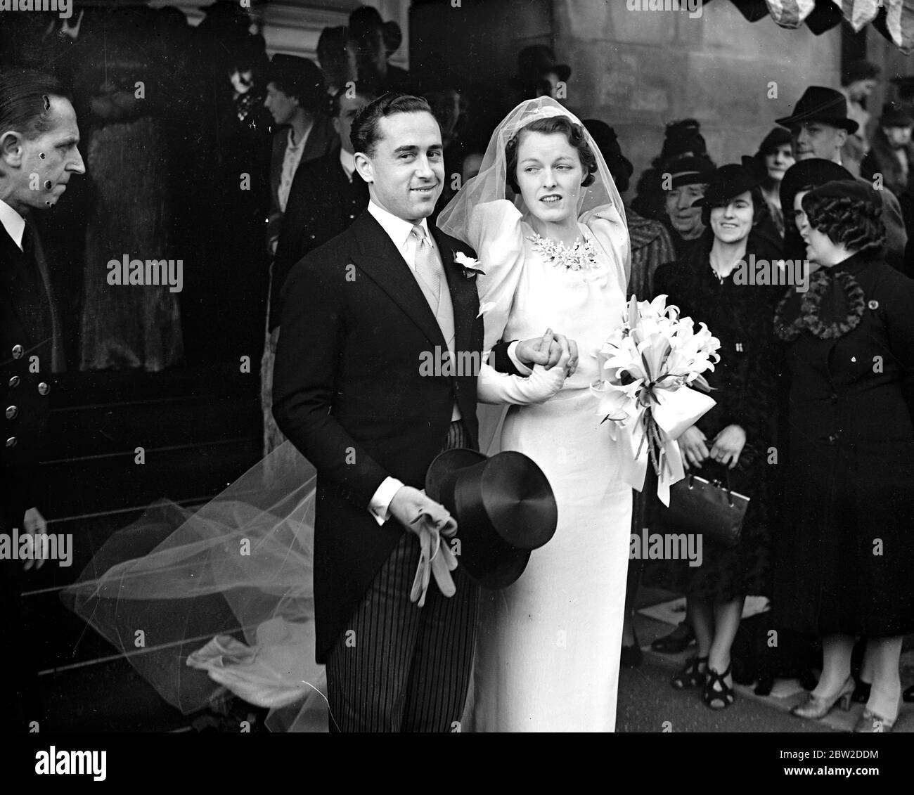 Wearing a white silver wedding gown with the train stiffened with glue ...