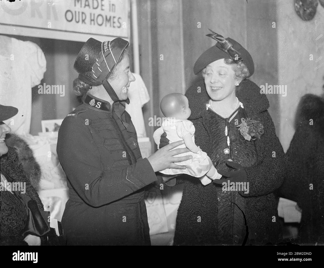 Mrs Neville Chamberlain receives doll at Salvation Army meeting. Mrs ...