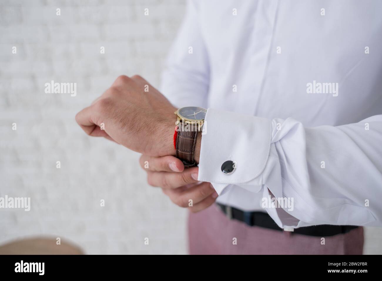 man puts watch on his hand Stock Photo - Alamy