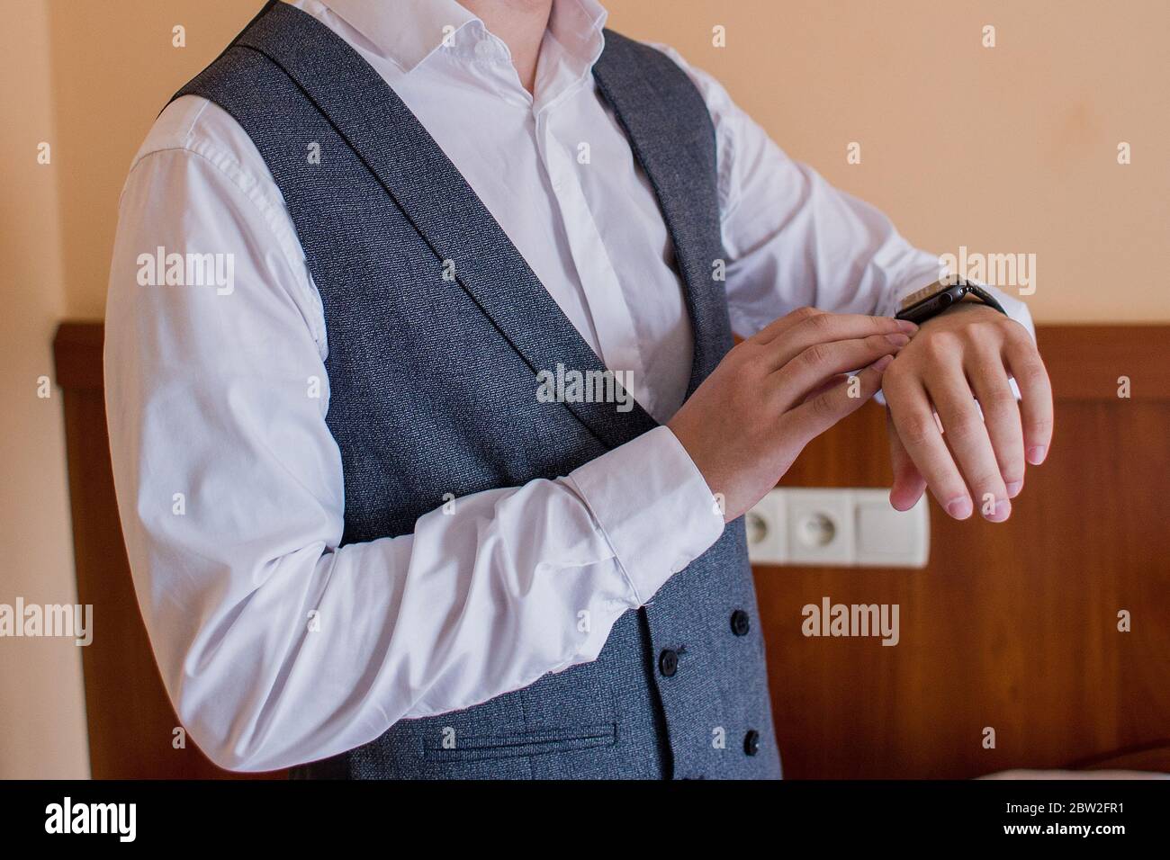 man puts watch on his hand Stock Photo - Alamy