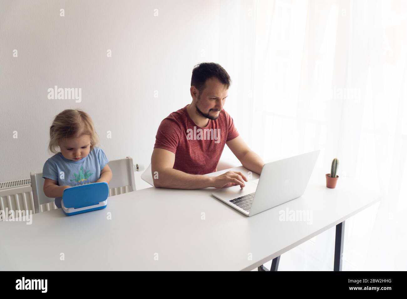 Man and child work at home Stock Photo - Alamy