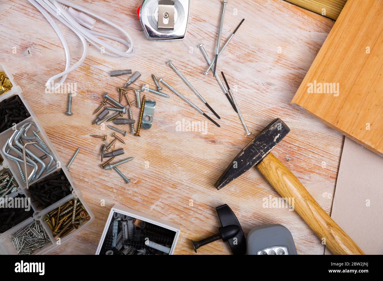 Set of fastening devices and hand tools on wooden background with place ...