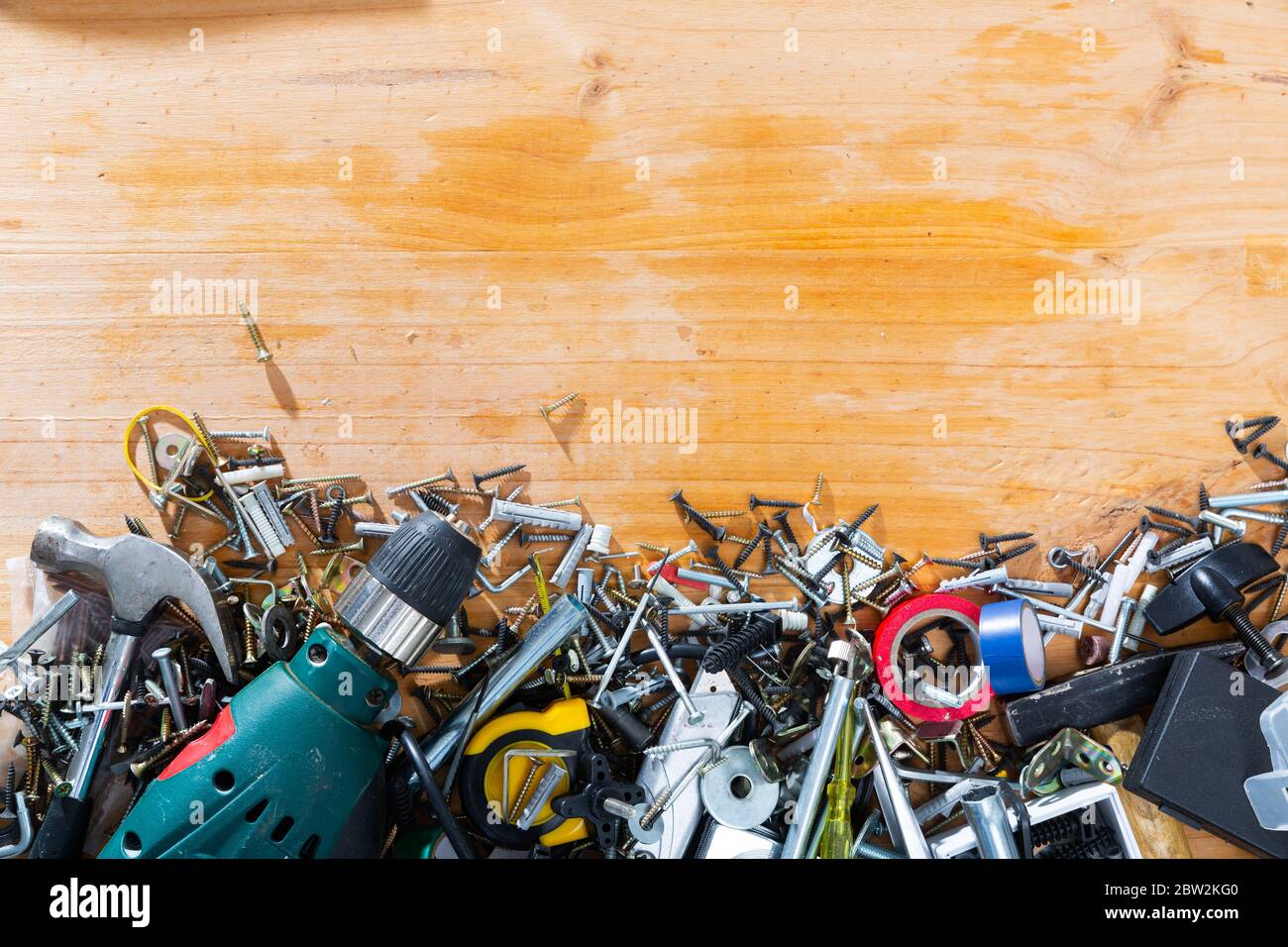 Set of fastening devices and hand tools on wooden background with place ...