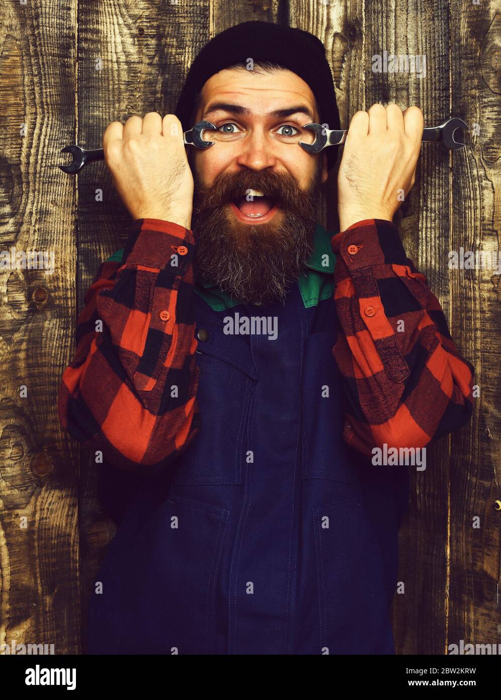 Bearded man, long beard. Brutal caucasian mechanic, smiling happy ...