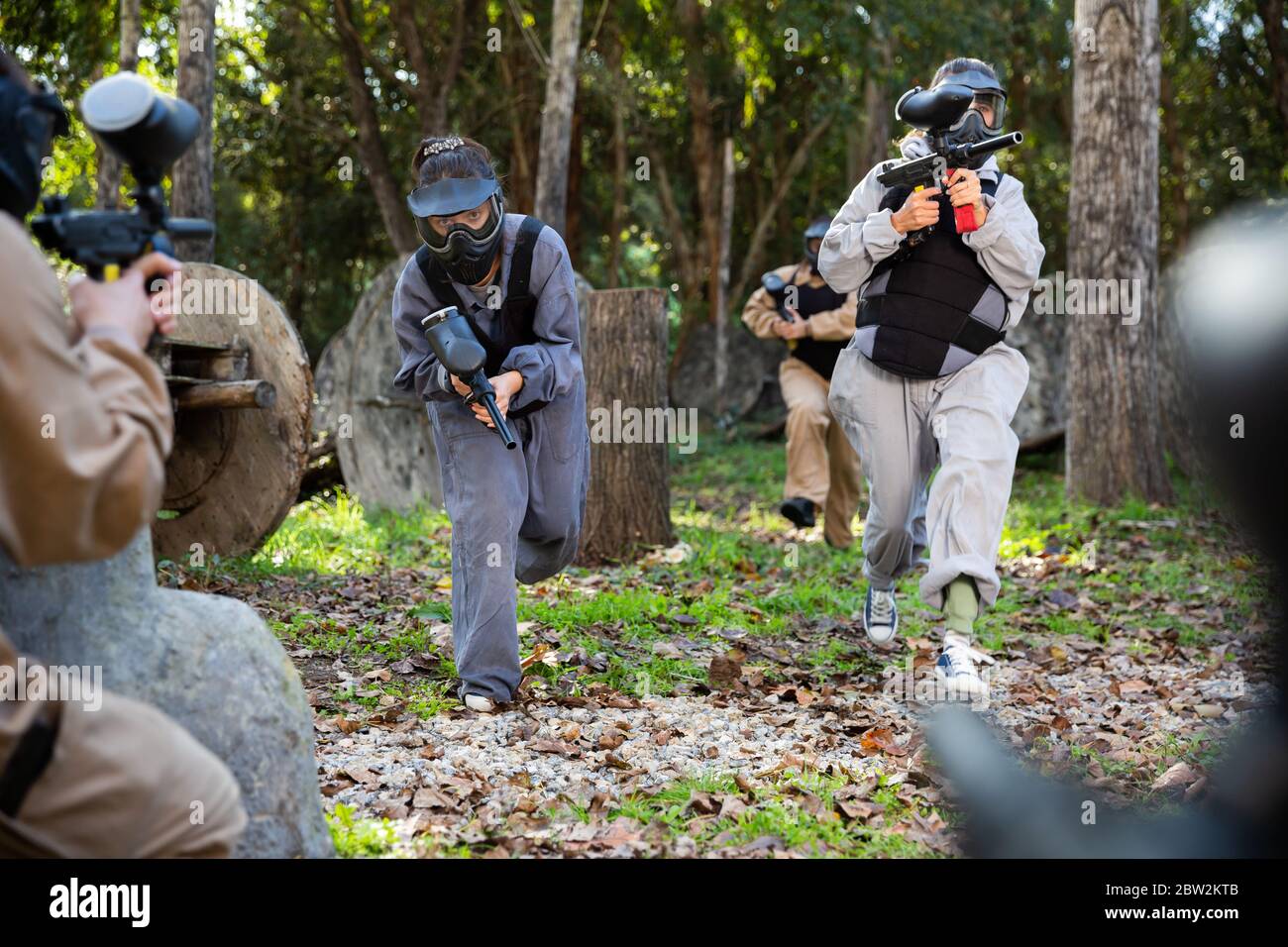 Group of people in full gear playing paintball on shooting range Stock ...