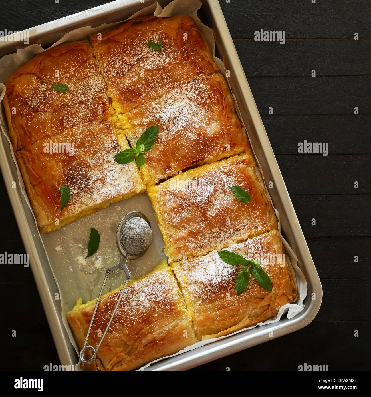 Concept of Greek cuisine. Homemade traditional greek Bougatsa, phyllo ...