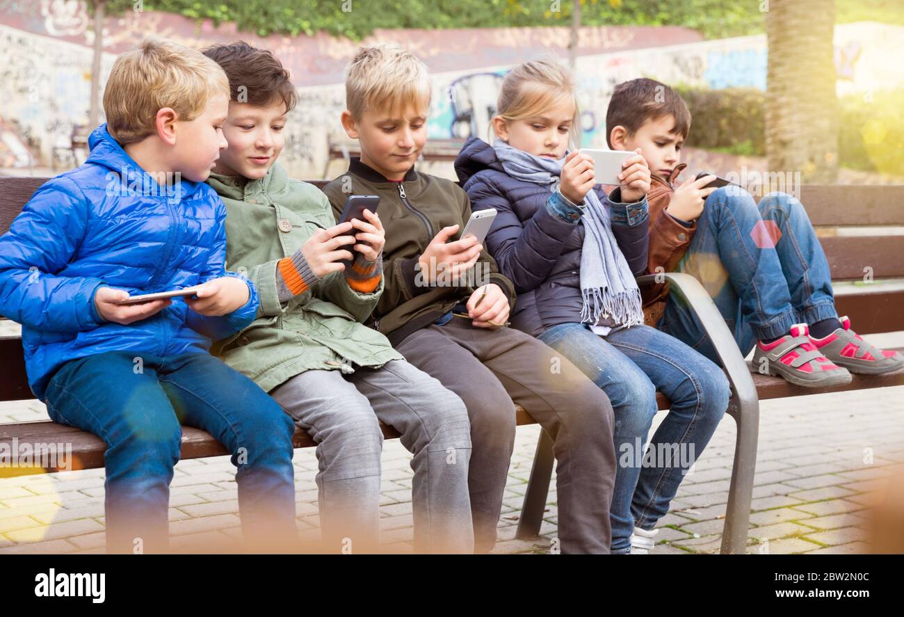 Children playing on smartphone outdoors Stock Photo - Alamy