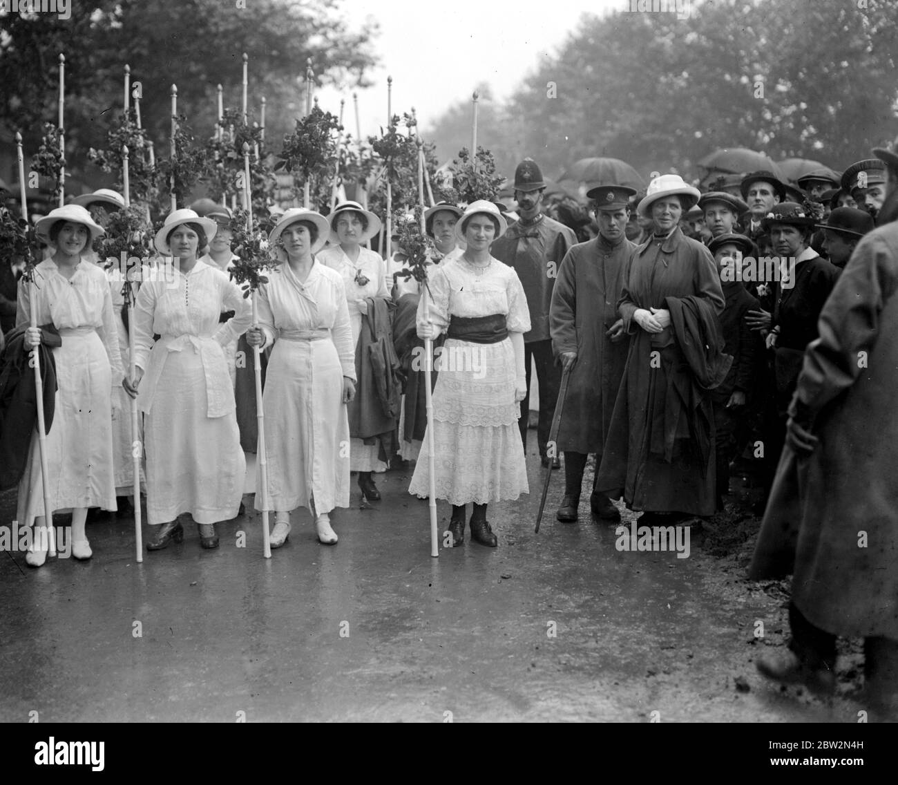 March of the women through London girls with crooks with red roses ...