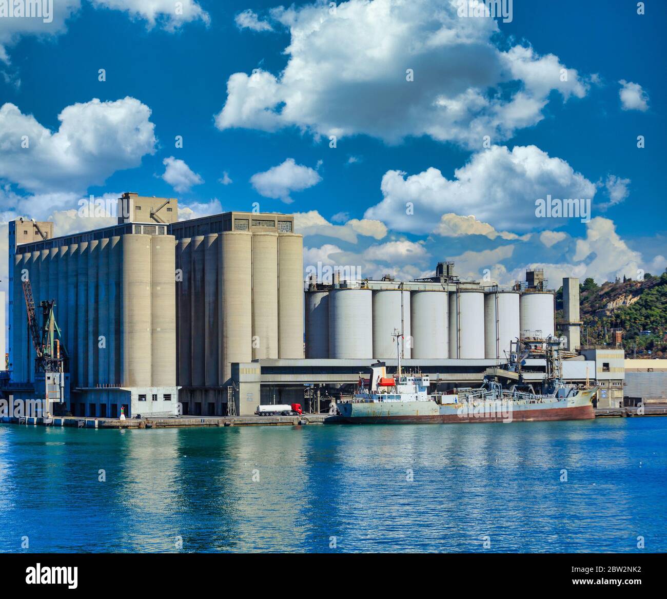 Concrete Shipping Silos and Old Tanker Stock Photo - Alamy