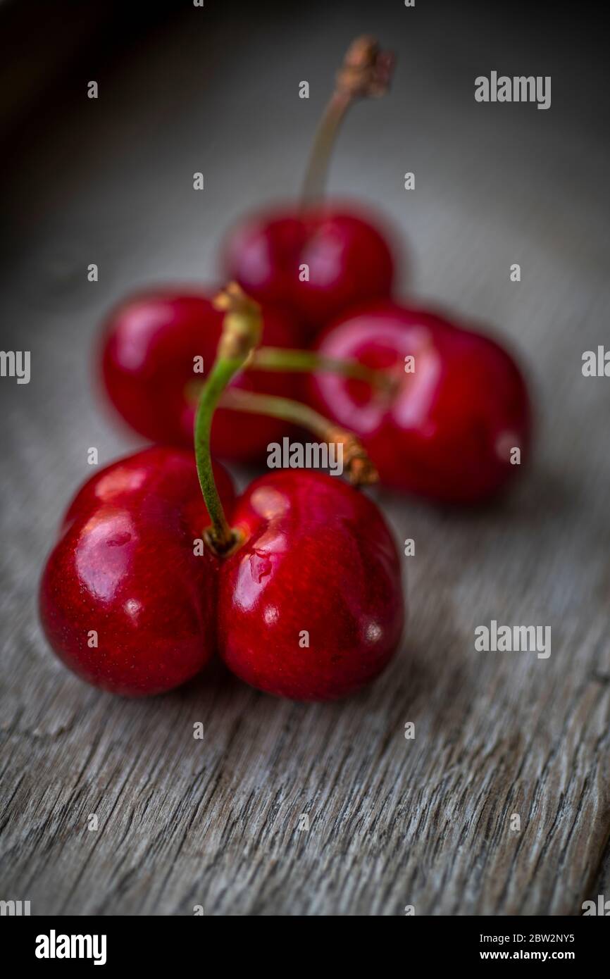 Cherry over a wood table Stock Photo - Alamy
