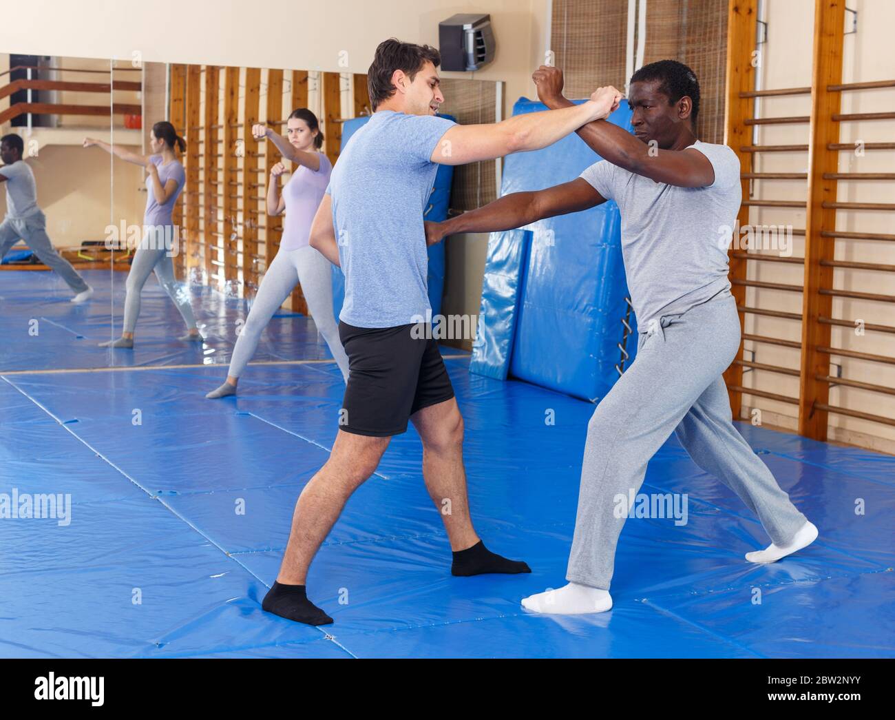 Men practicing effective techniques of self-defence during individual ...