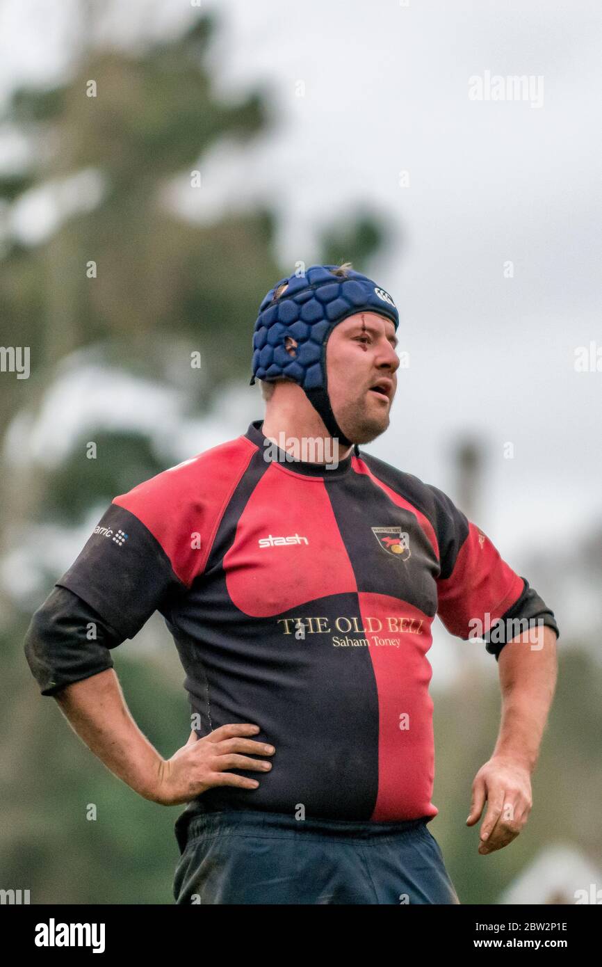 Senior player catches his breath, a trail of blood running down his ...