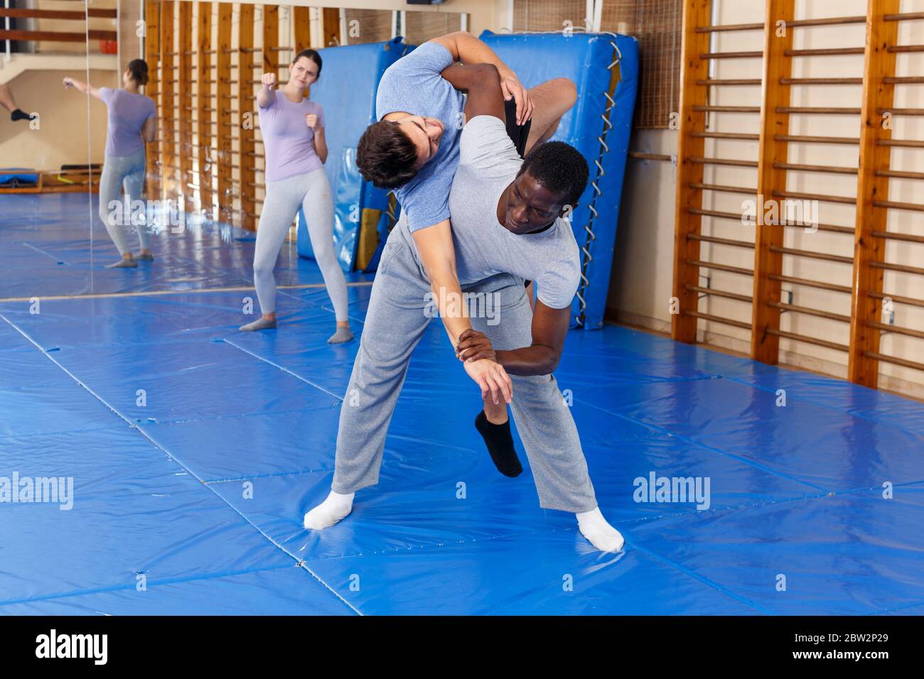 Males training attack movements in pair at self protection workout ...