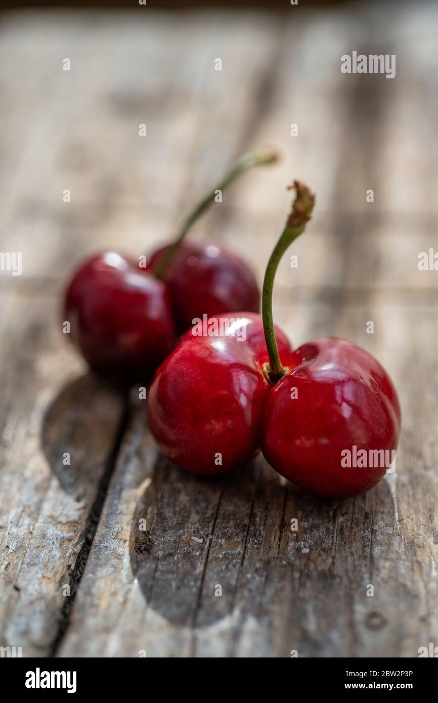 Cherry over a wood table Stock Photo - Alamy